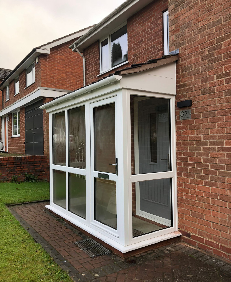 A bright, fresh white uPVC porch from our Elegance range and a grey ...