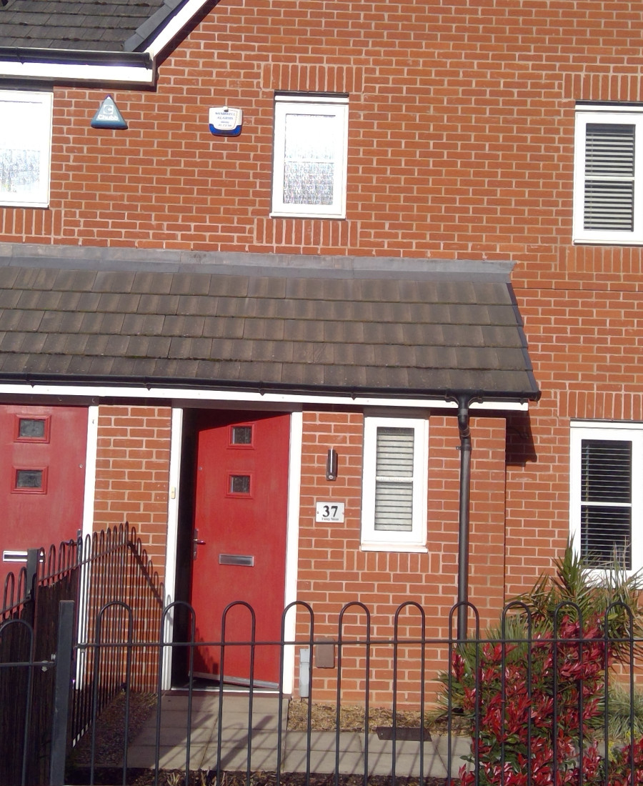 A faded, composite door exactly the same as every one of the neighbours.